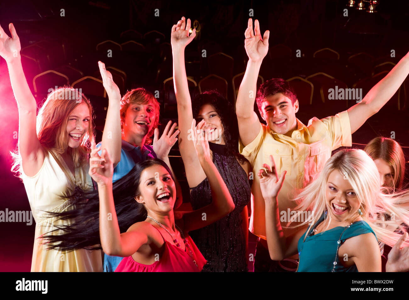 Portrait of dancing people raising hands and laughing Stock Photo - Alamy