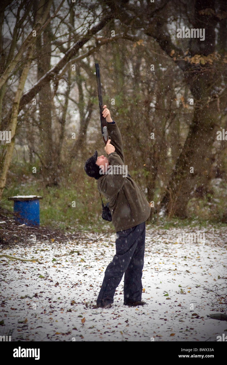 man shooting shotgun in snow Stock Photo - Alamy