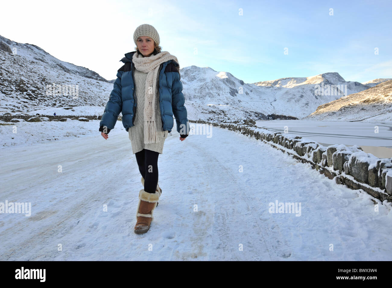 woman walking on icy path Stock Photo - Alamy