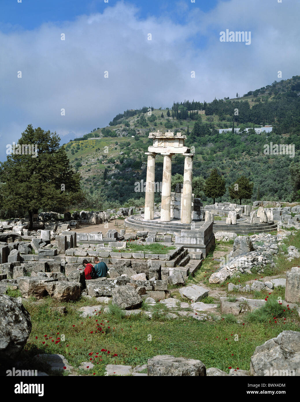 Delphi ruins Ancient world antiquity column rotunda Tholos tourist pair ...