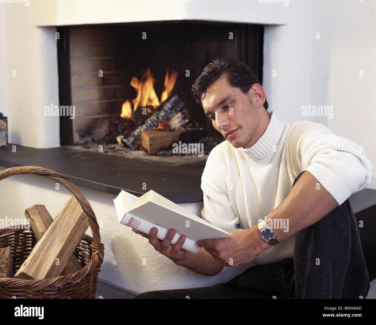 fireplace fire peaceful crouch sit read man sitting room contently ...