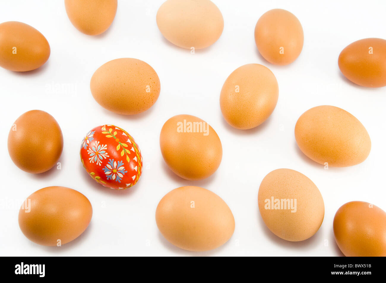 hand painted red egg among natural eggs Stock Photo - Alamy
