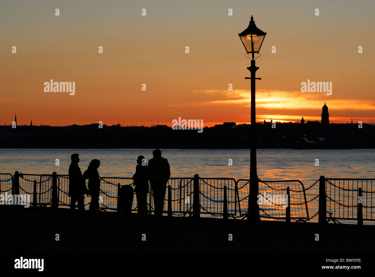 People enjoying the sunset over the River Mersey on the Liverpool ...
