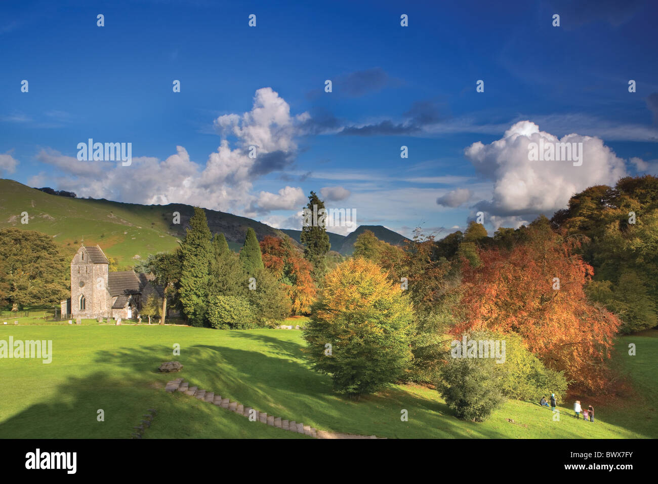 Autumn view of Ilam church, Ilam Park with Thorpe cloud (Dovedale) in ...