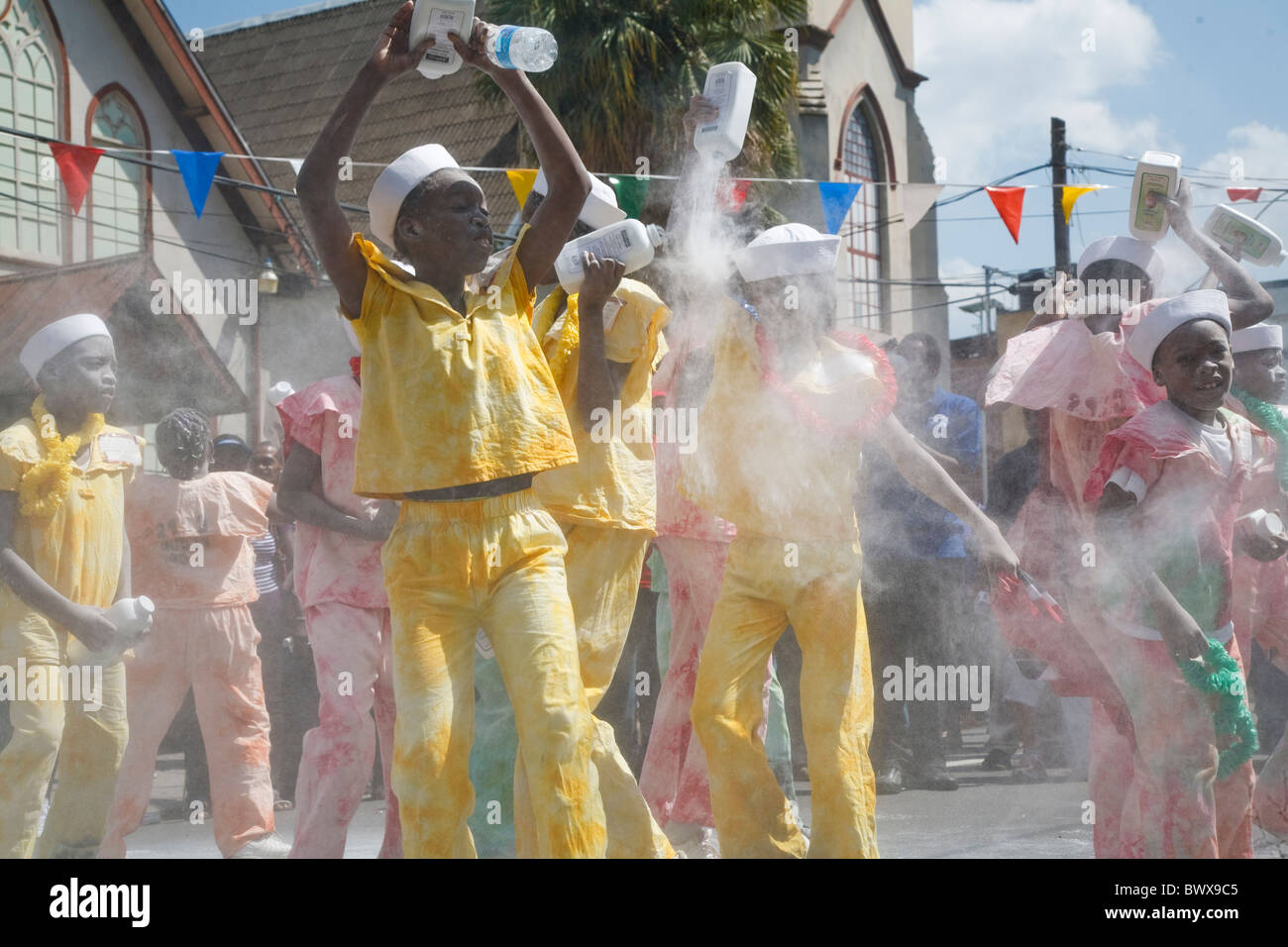 Junior traditional Mas parade girl sailors throwing powder and dancing ...