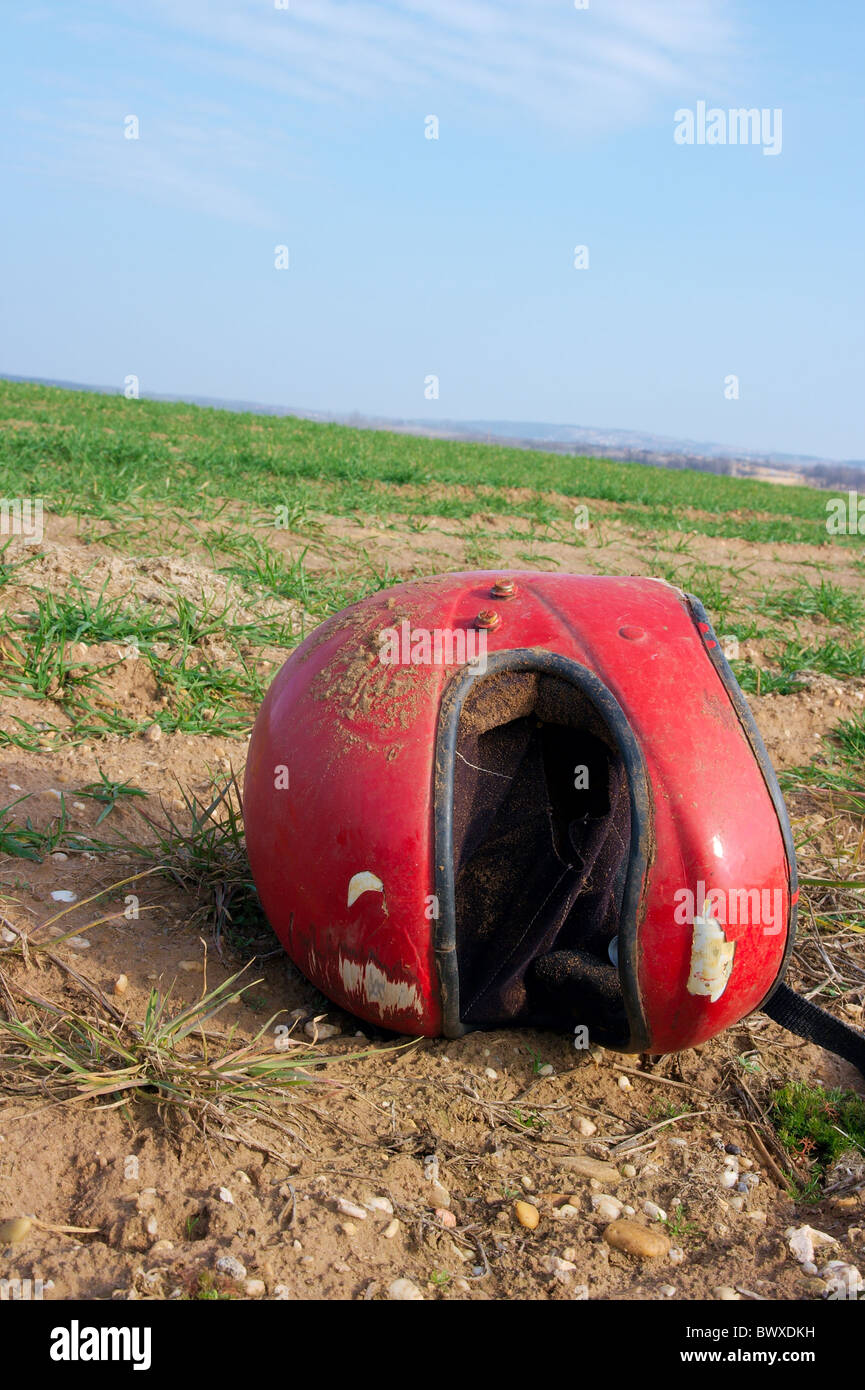 Broken red helmet on a rural field Stock Photo - Alamy