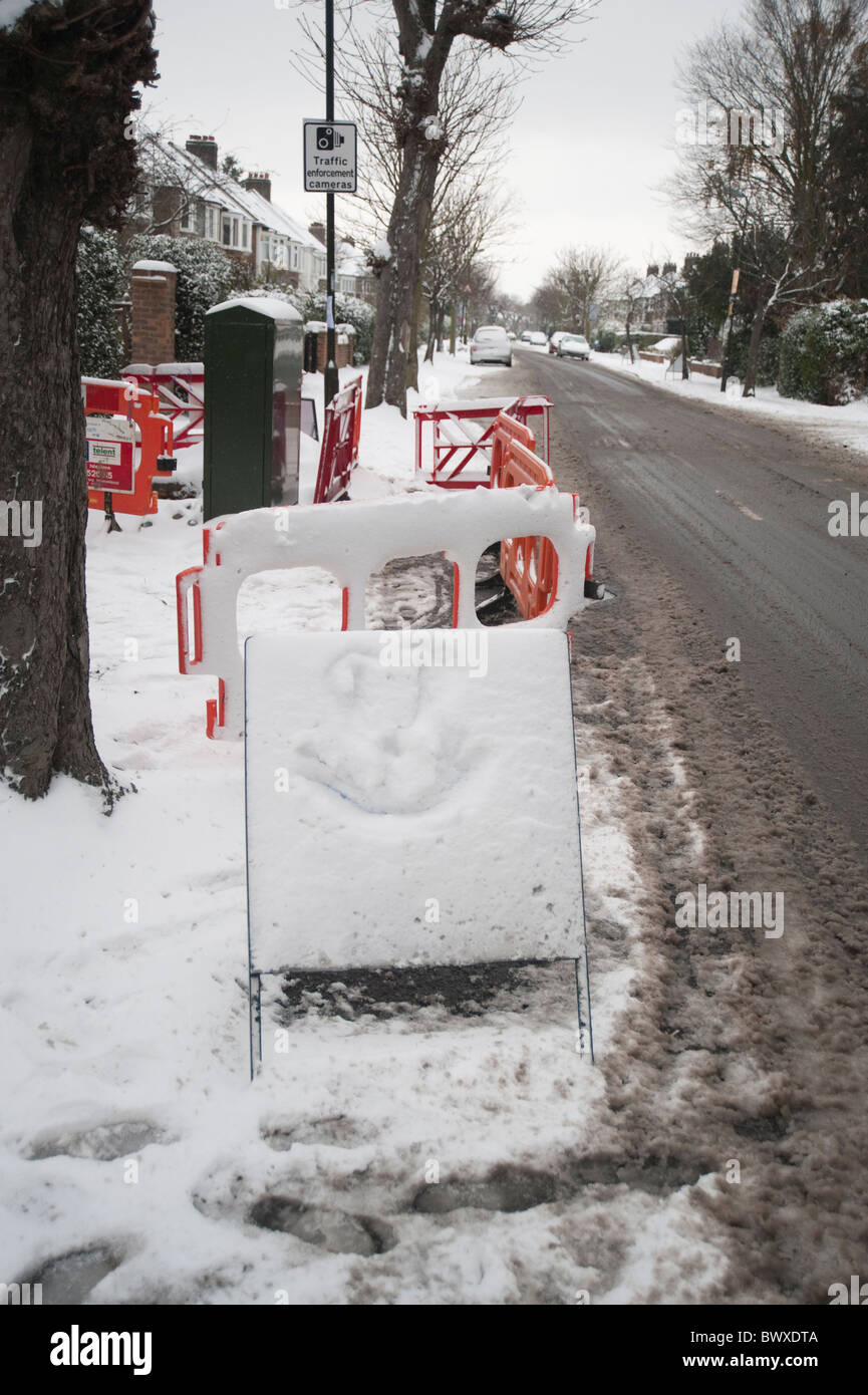 Snow Covered Warning Sign and Roadworks Stock Photo - Alamy