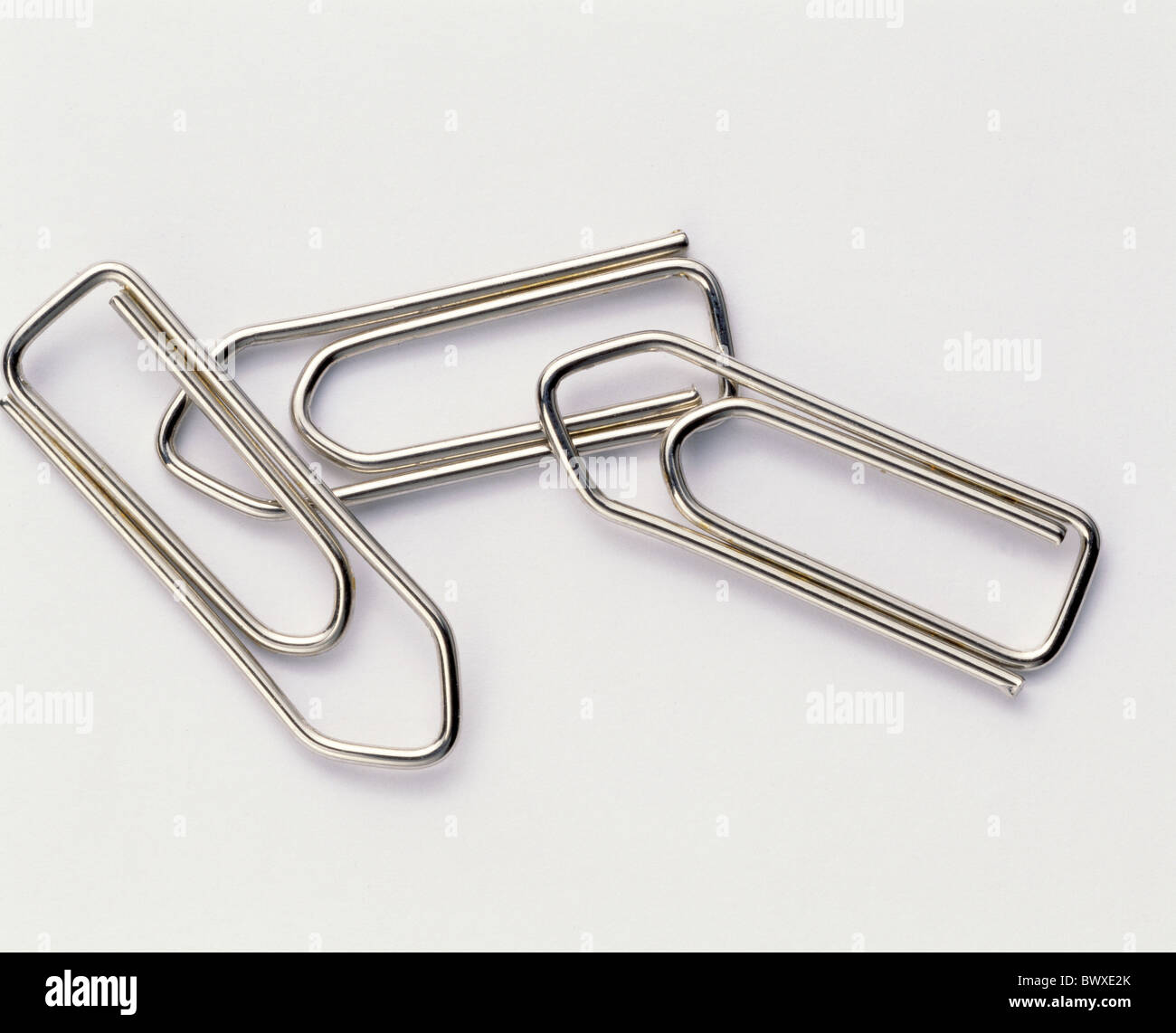 office symbol paper clips three studio white background Stock Photo - Alamy