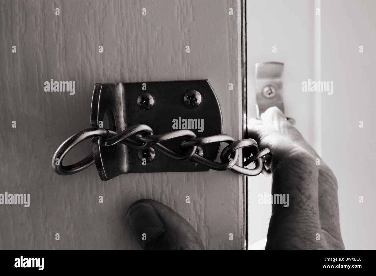 Scared woman opens door hi-res stock photography and images - Alamy