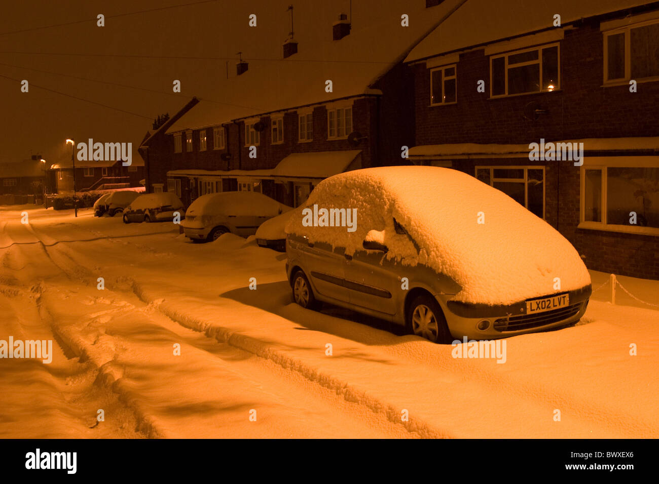 night snowing snow scene street lighting amber Stock Photo - Alamy