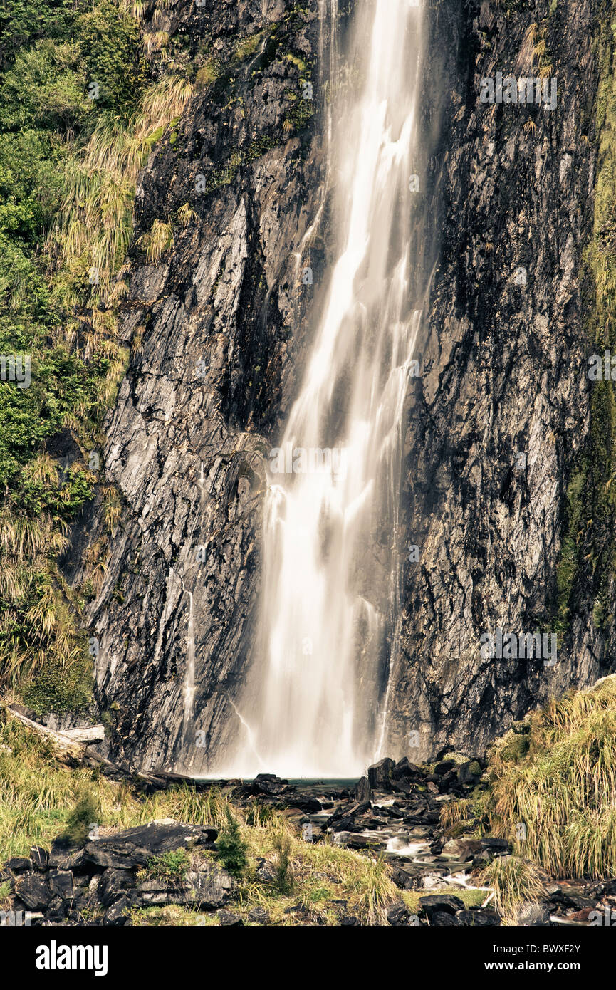 A misty looking photo of a Thunderfalls waterfall on the Haast Pass in ...