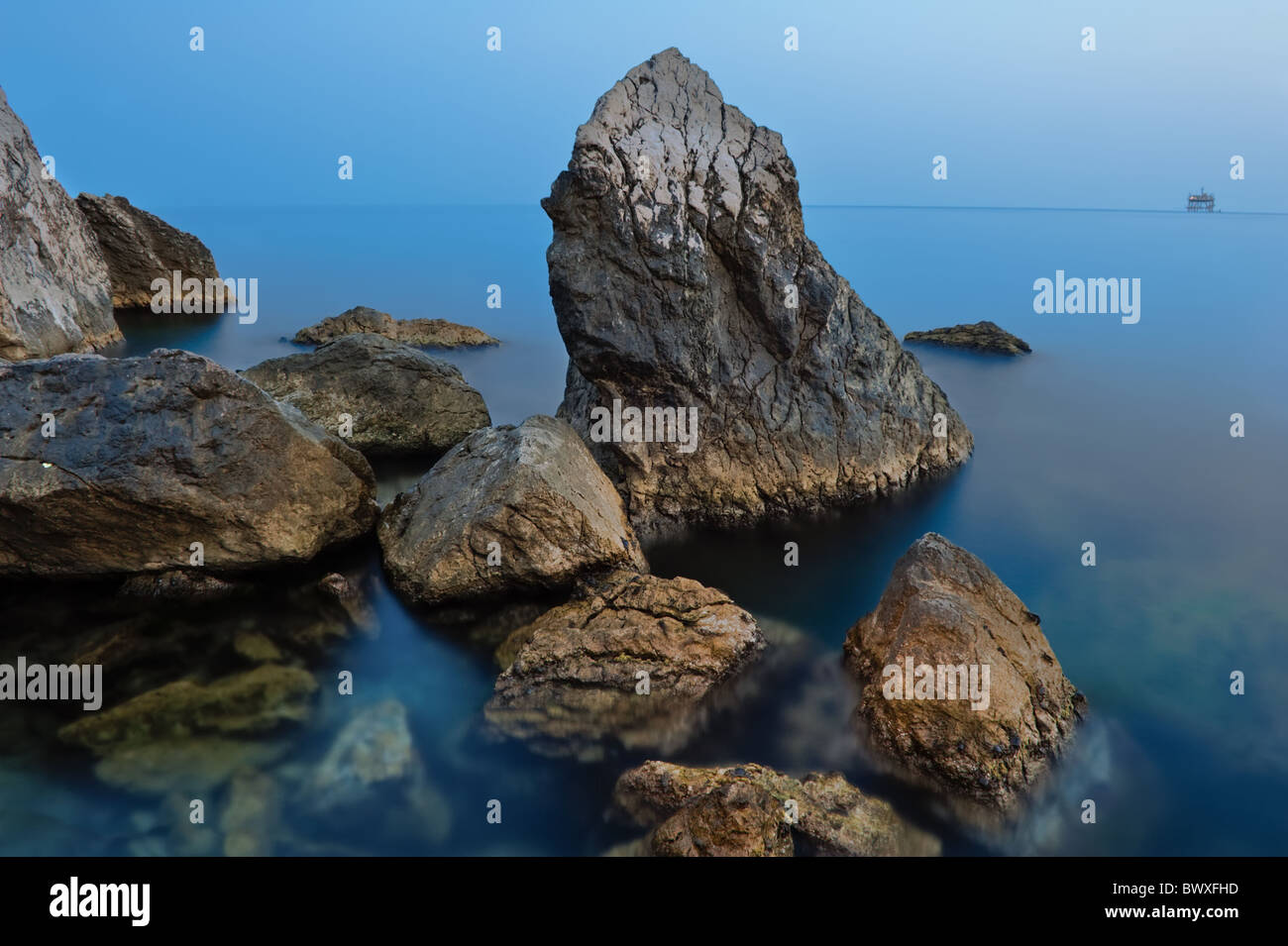 Stones in night sea Stock Photo - Alamy
