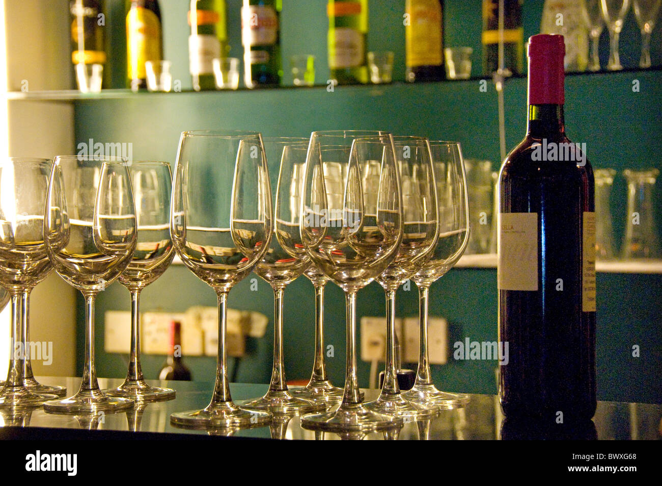 Wine bottle and wine glasses sitting on bar counter in restaurant Stock ...