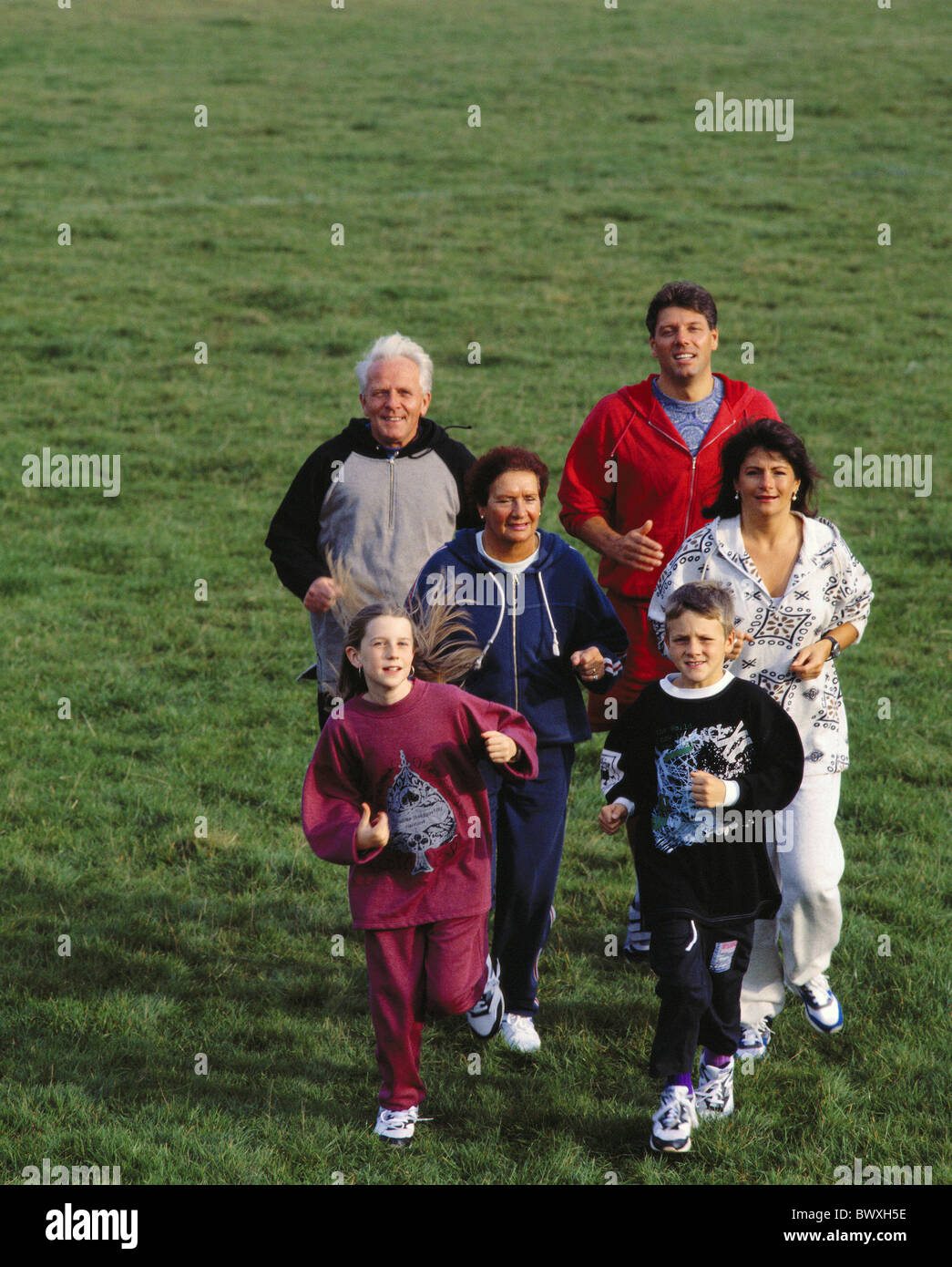 2 children 4 adults action family jogging fitness jogging sport lawn ...