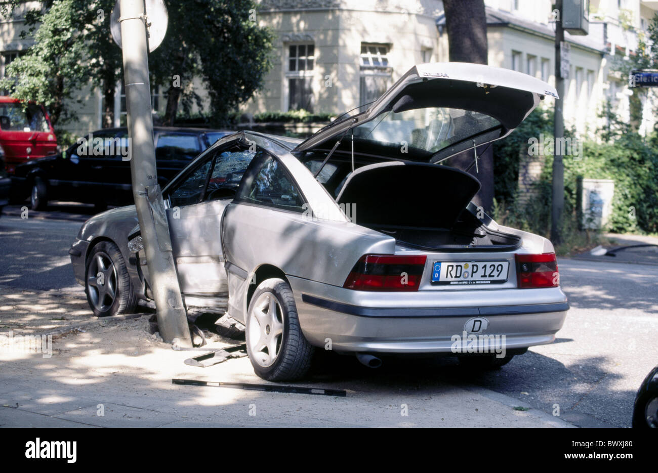 gray car automobile mast pole damage harm side pushed street traffic ...