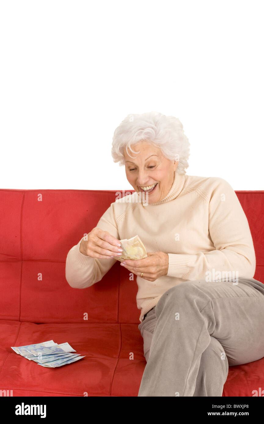 elderly woman on the couch with money in hand Stock Photo - Alamy