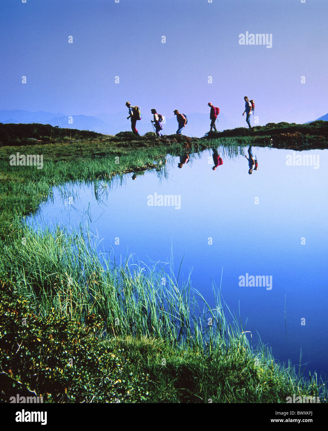 mountains grass ridge group plateau lake sea reflection traveling group ...