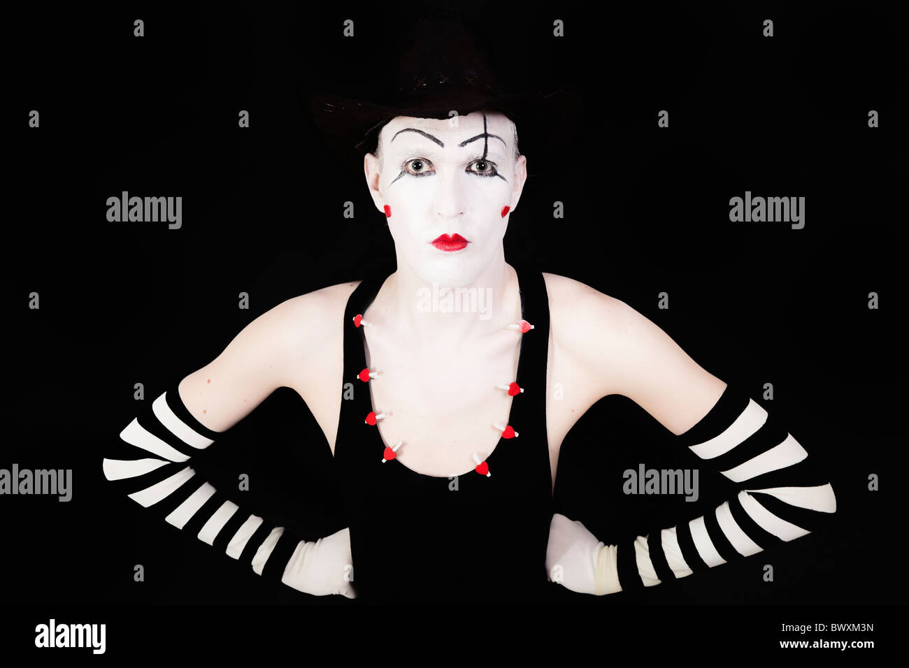 Portrait of pantomime actor with makeup on black background close up ...