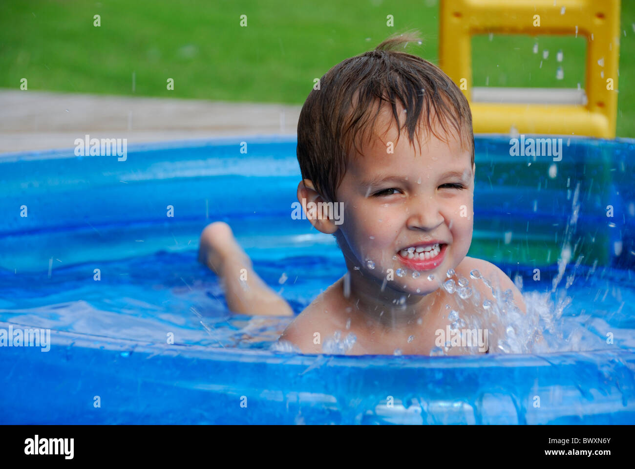 Young Boy Swimming And Having Fun In Swimmingpool Stock