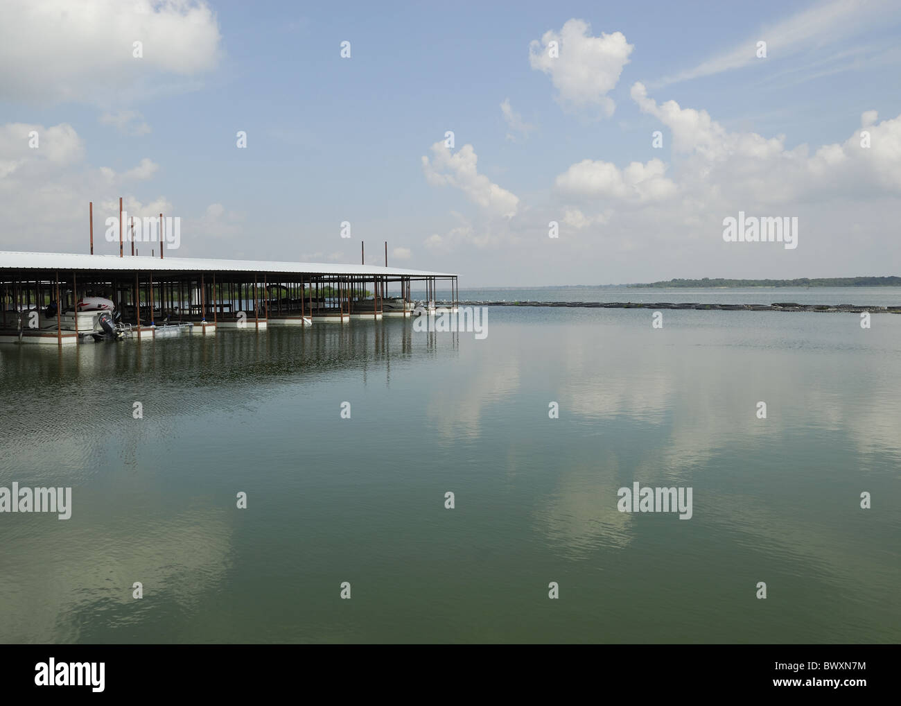 Boat marina on lake with the sky and clouds reflecting in the lake ...