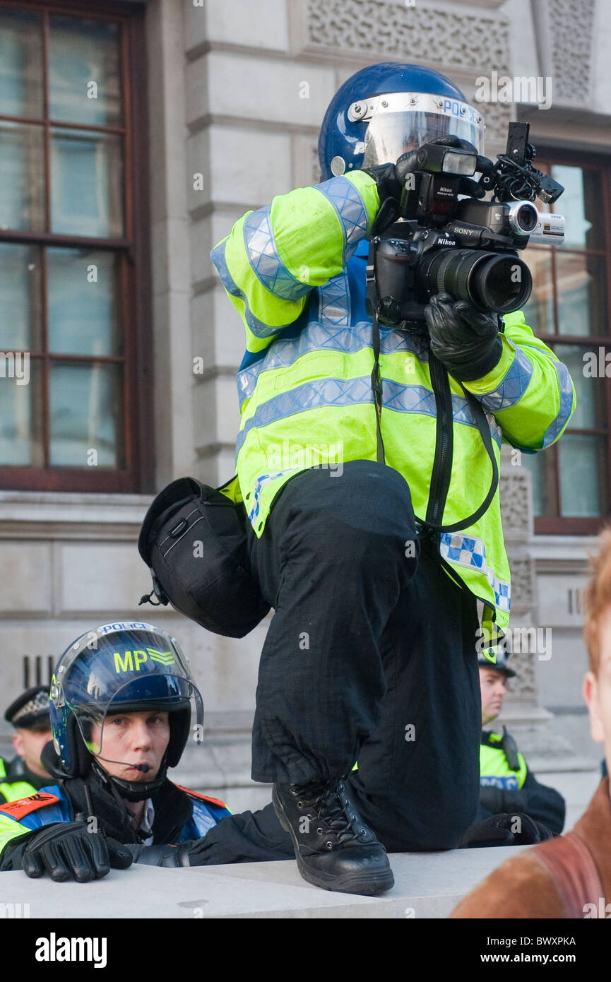 A metropolitan police officer gathering photographic evidence during a ...