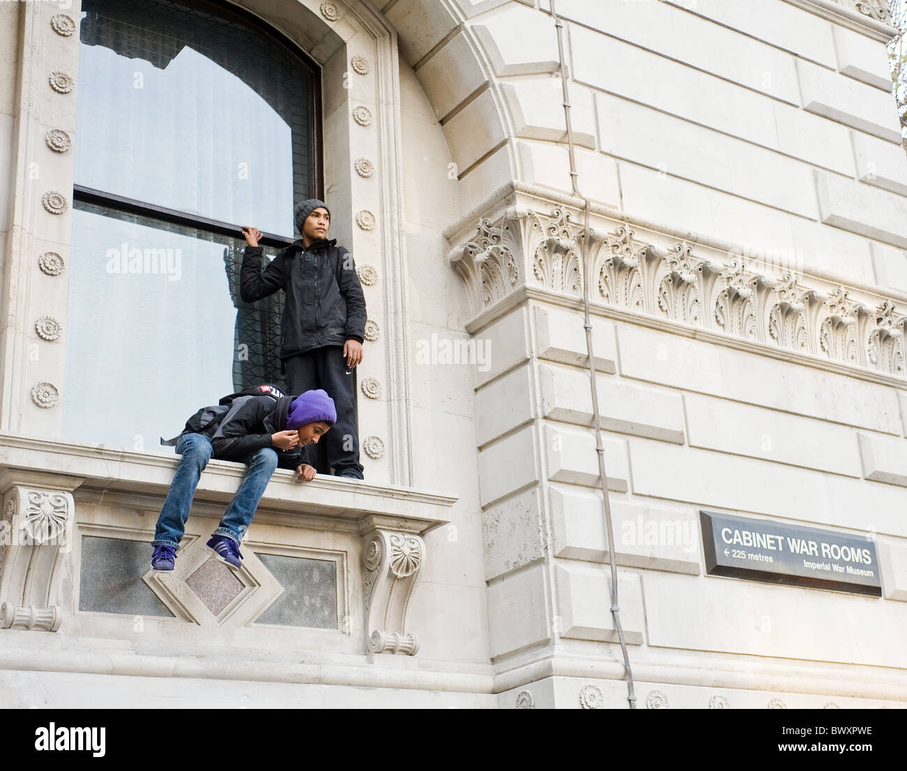 Students on a window ledge at a demonstration in London. Photo by ...