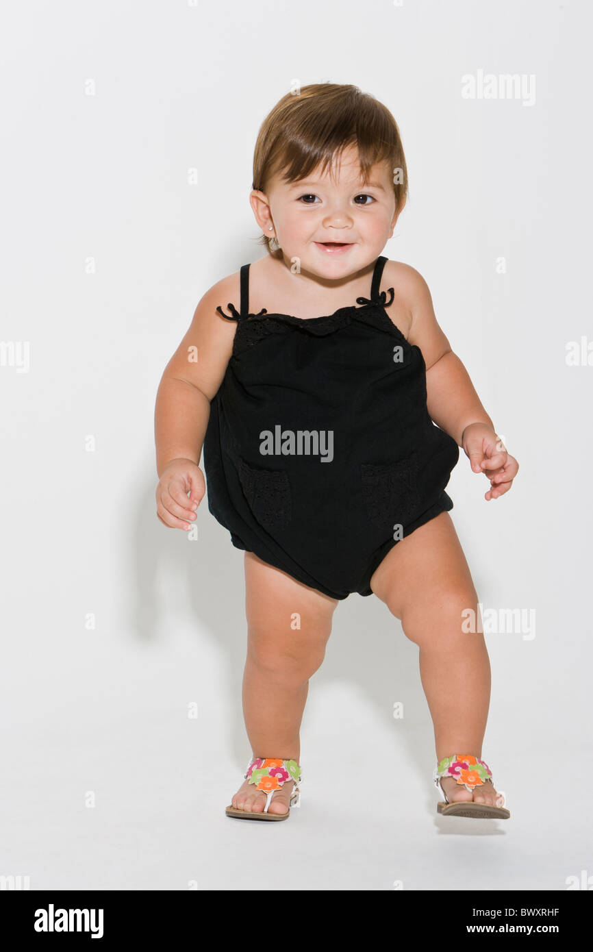 Baby girl doing her first steps, Studio Shot Stock Photo - Alamy