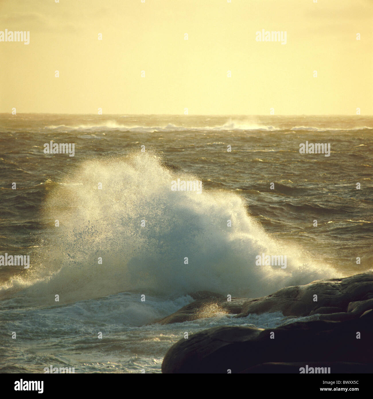 evening light Bohuslan surf waves rocks cliffs coasts foam Sweden ...