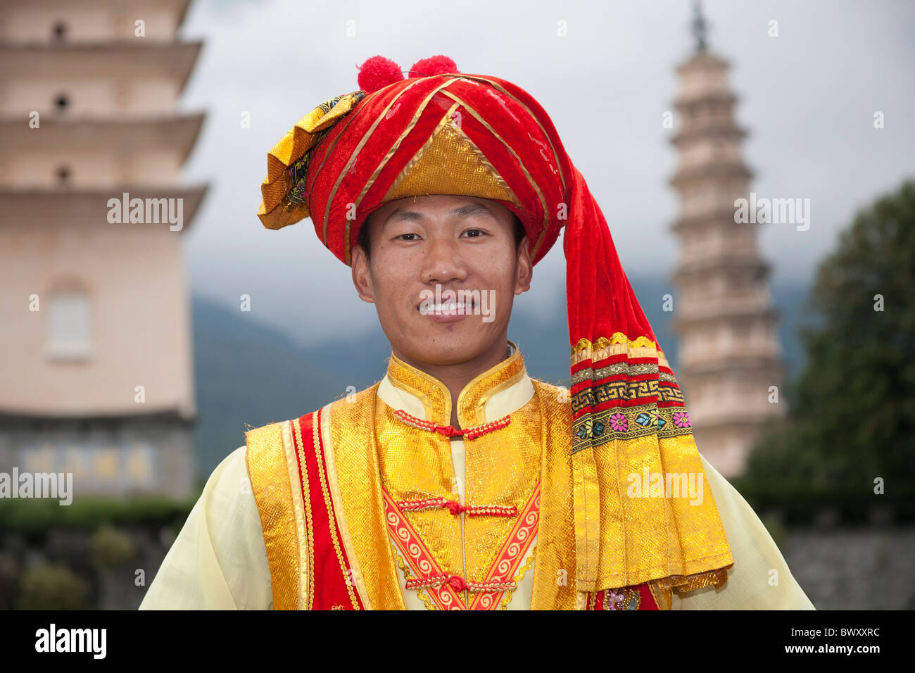 Man wearing a colourful costume and hat, Dali, Yunnan Province, China ...