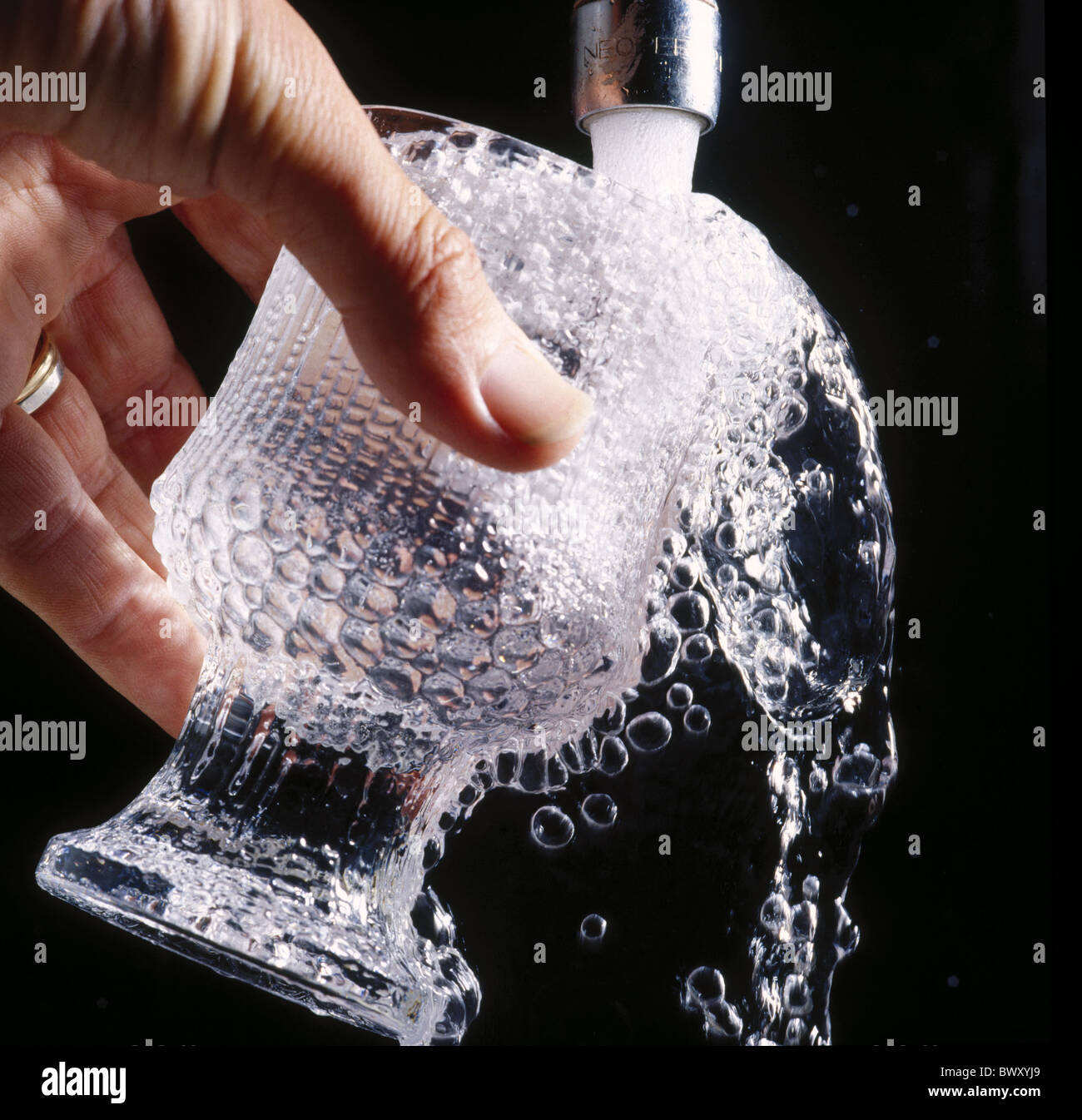 glass Hahnenwasser hand fizzy water cleanly well purely Stock Photo - Alamy