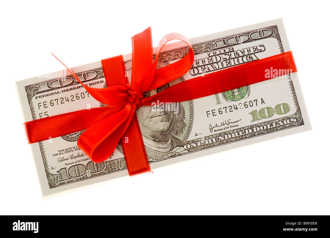 Photo of pack of dollars decorated with red ribbon over white ...