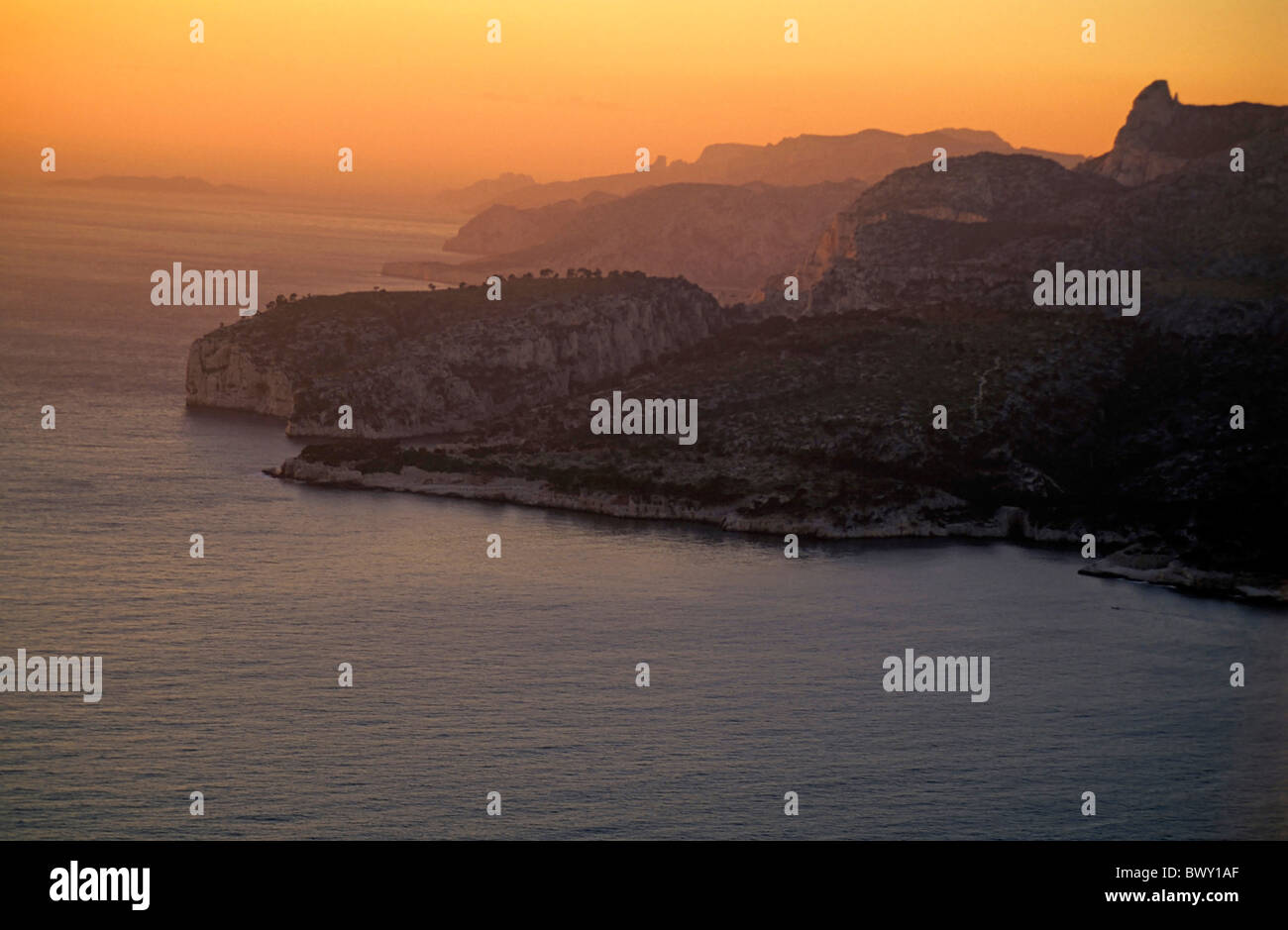 Sun setting over the limestone rock faces of Les Calanaques, Marseille ...