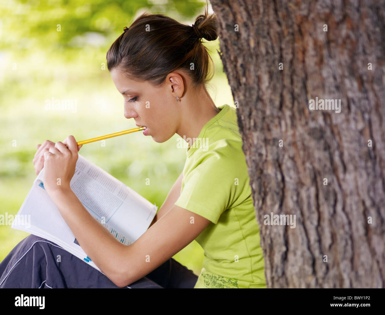 Woman student sitting thinking while studying. Isolated on white ...