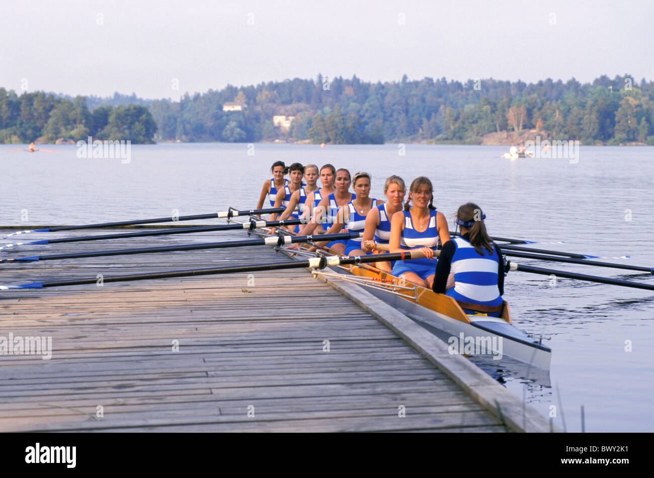 eight group lake rowing boat sports team rowing oar women woman people ...