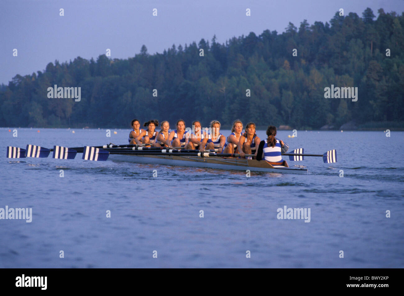eight group lake rowing boat sports team rowing oar women woman people ...