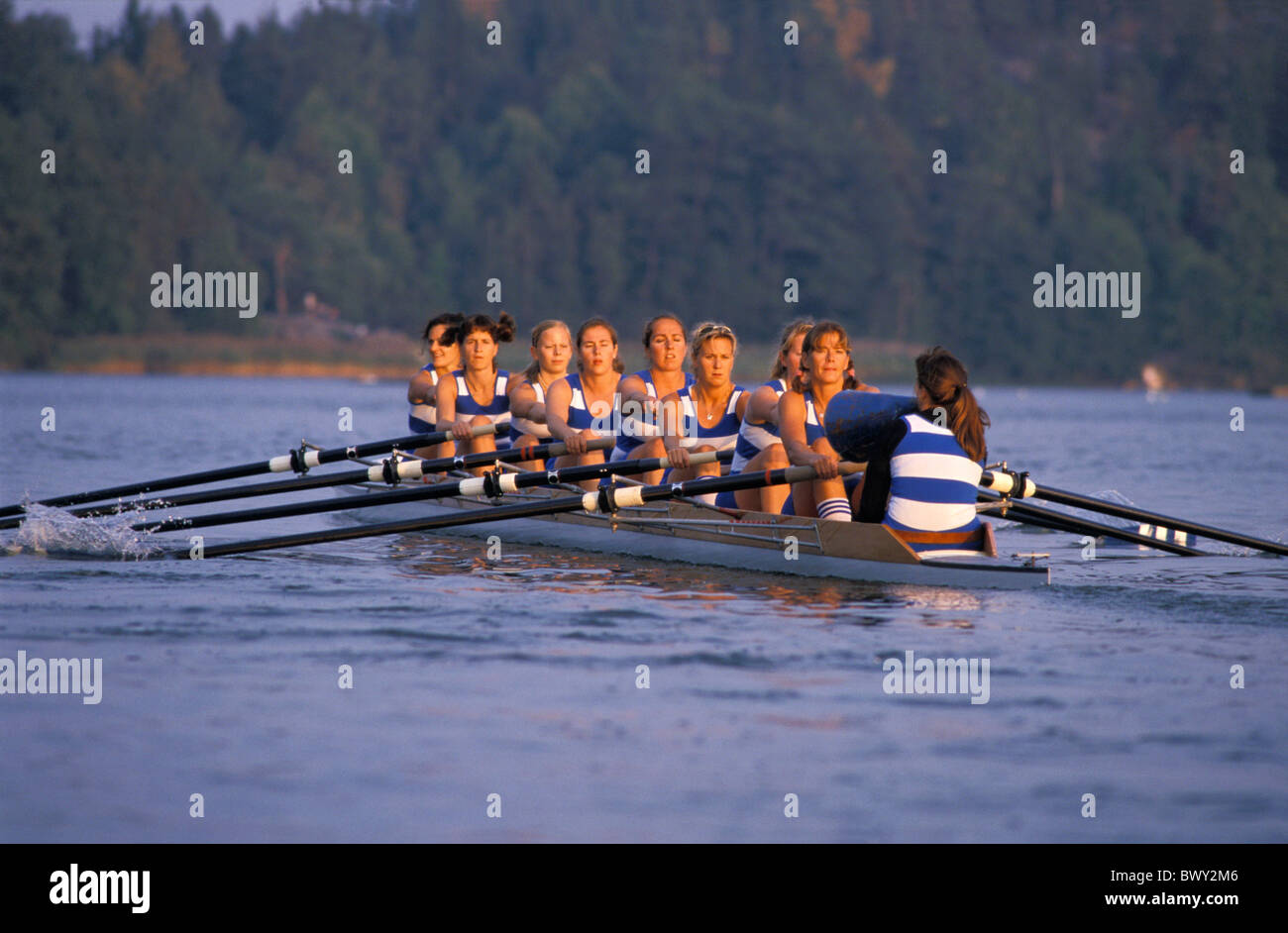eight group lake rowing boat sports team rowing oar women woman people ...