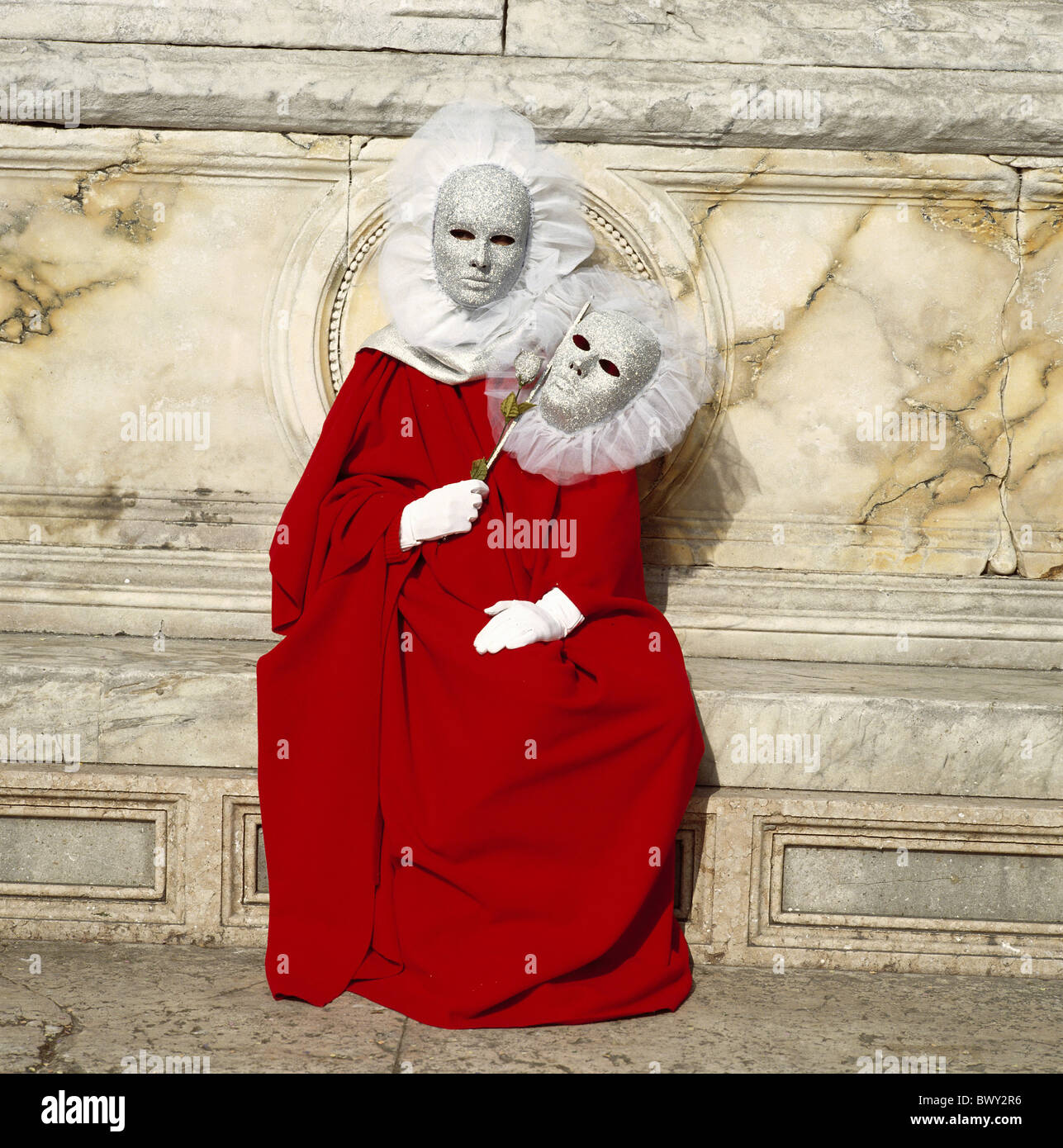 Italy Europe carnival larva marble wall portrait red costume sit Venice ...