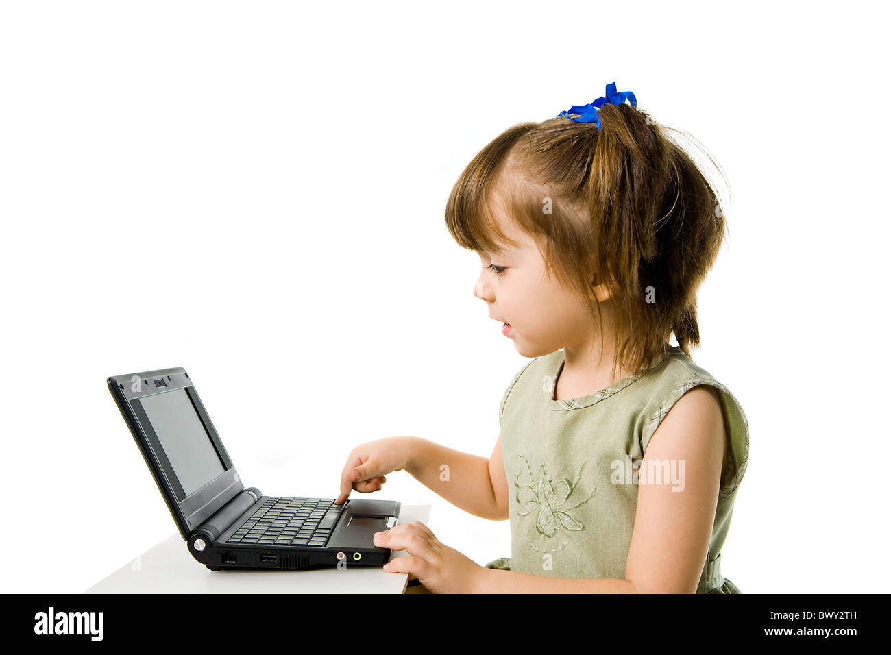 Photo of smart preschooler going to pushing button of laptop keyboard ...