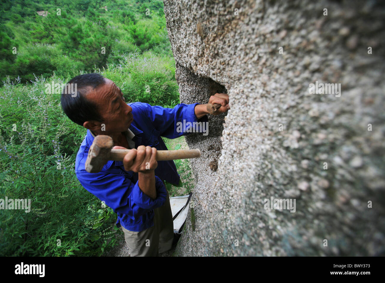 Chinese man drilling a hole on the cliff, Gu Ya Ju Ancient Caves ...