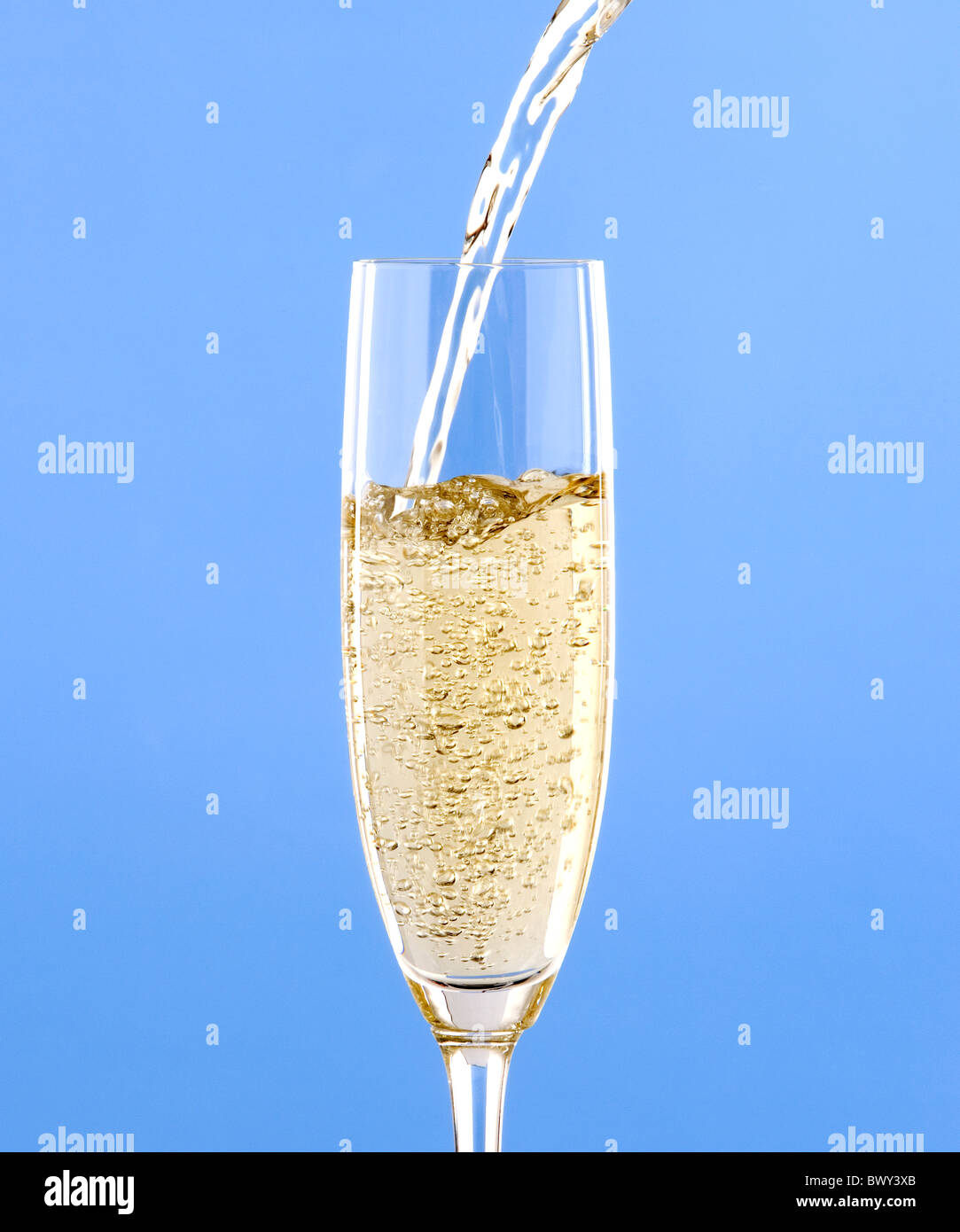 drink pour into glass with light blue background Stock Photo - Alamy