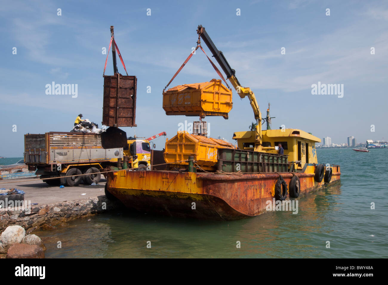 The garbage boat from Island is loading garbages from Boat to Truck for ...