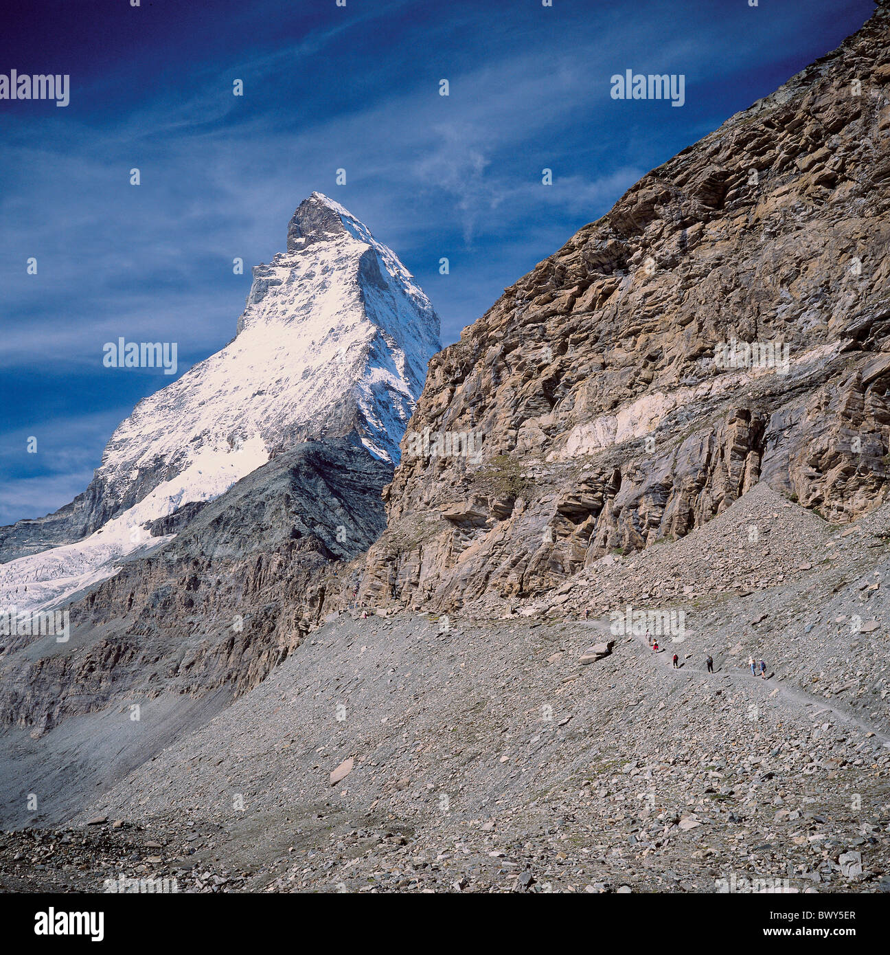 walking hiking group remote stone waste dump Matterhorn landmark ...