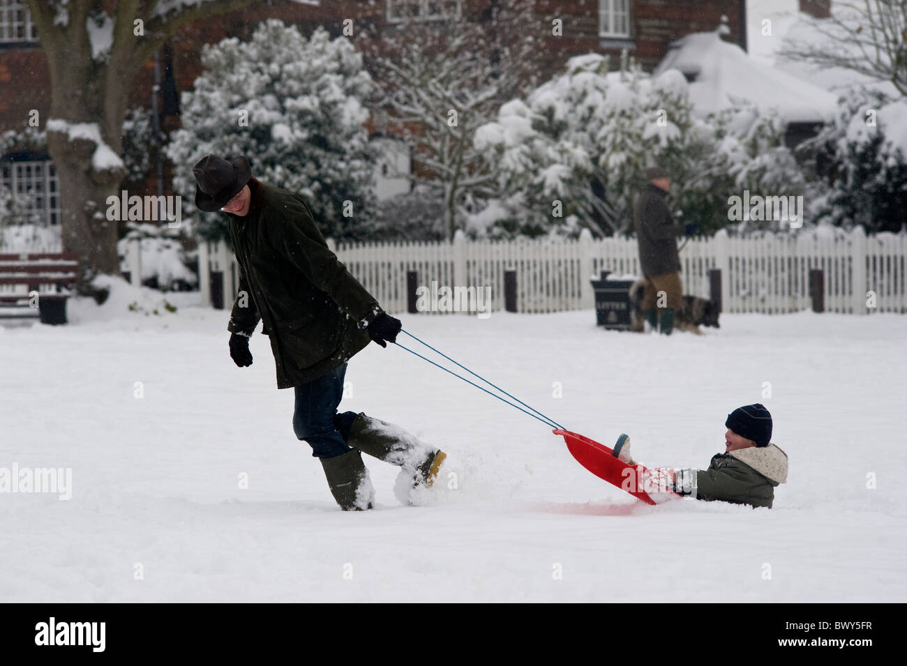 Father playing with son in snow as England is hit by the worst storm in ...
