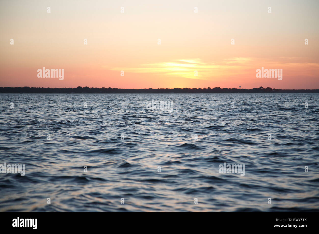 Sunset Over Water Stock Photo - Alamy