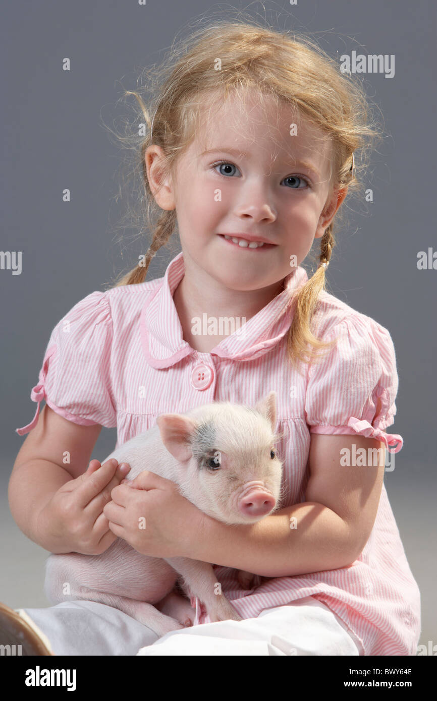 Girl with Piglet Stock Photo - Alamy