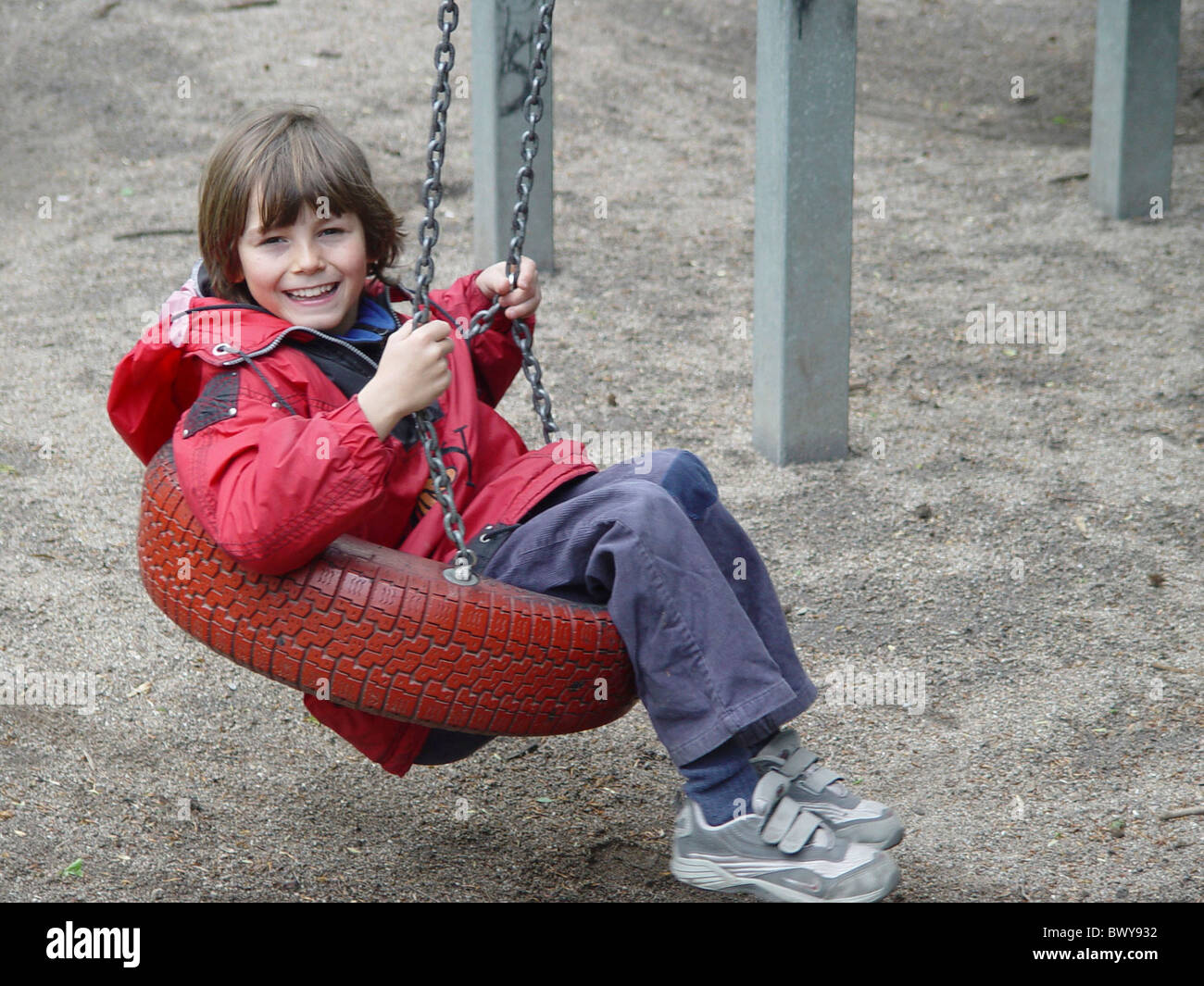 tires boy child boy laugh Pneu portrait swing swinging rocking sit fun ...