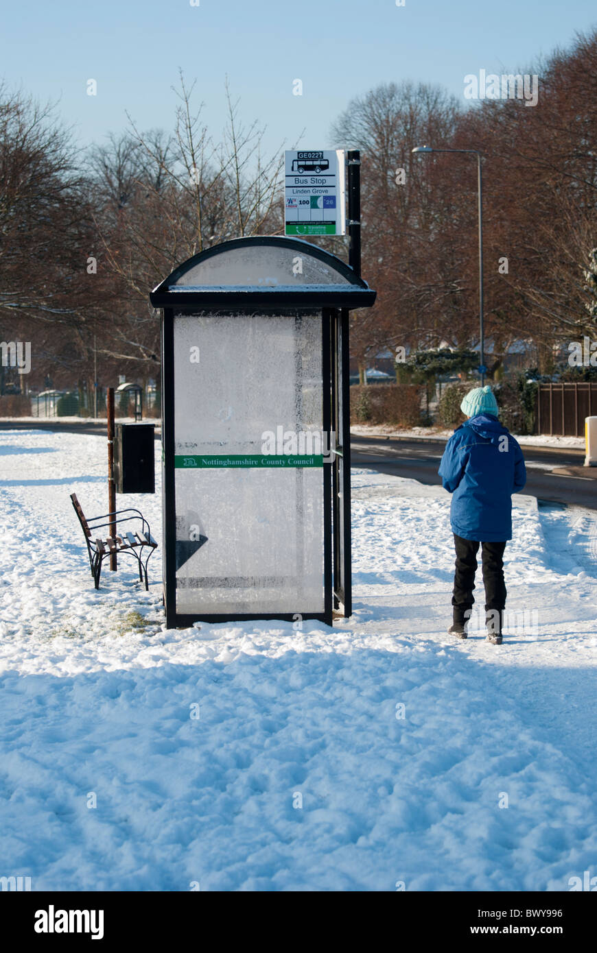 Snowy scene of a commuter waiting at a rural bus stop Stock Photo - Alamy