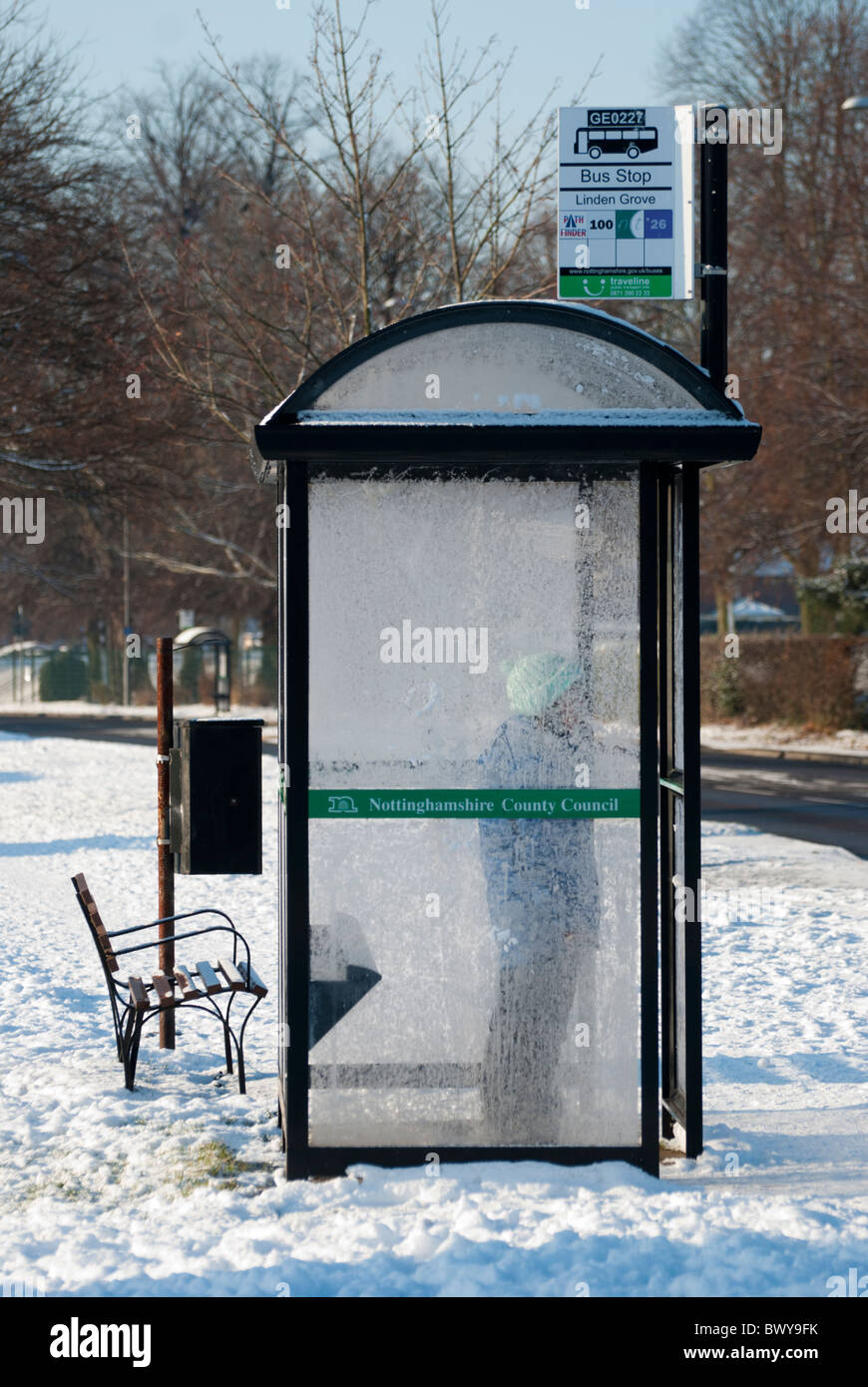 Snowy scene of a commuter waiting at a rural bus stop Stock Photo - Alamy
