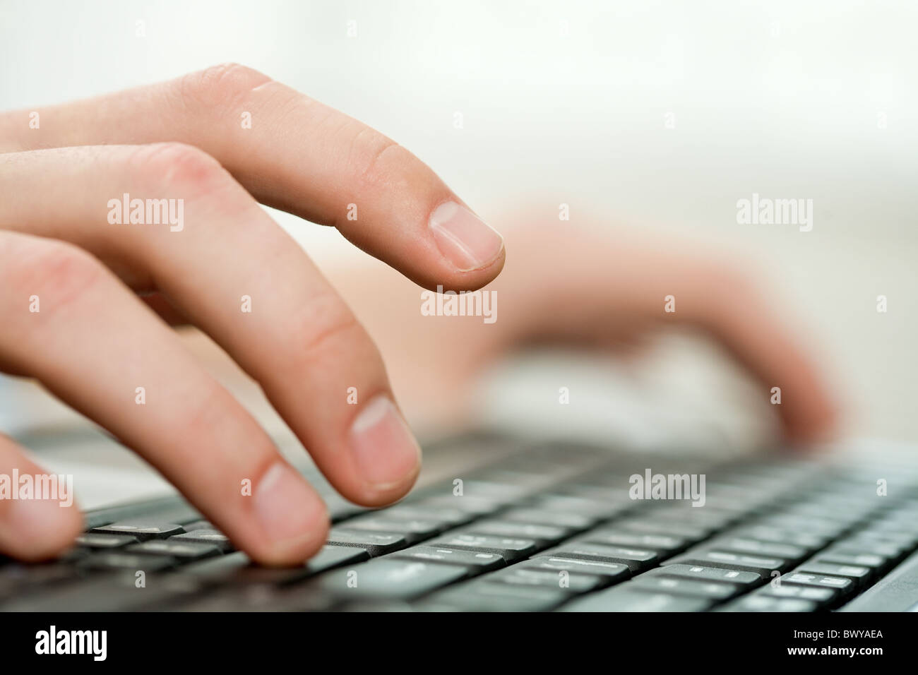 Close-up of male hand over keyboard of laptop during computer work ...