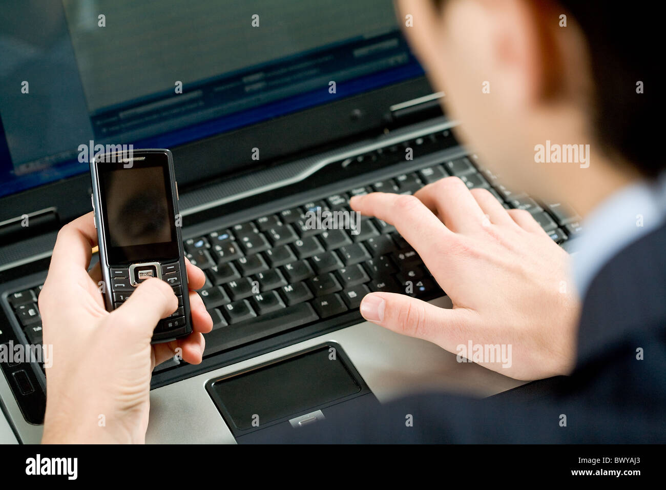 Photo of male holding cellular phone and pressing its buttons while ...